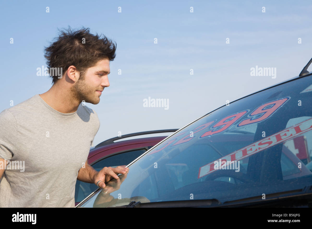 A man looking at a car Stock Photo - Alamy