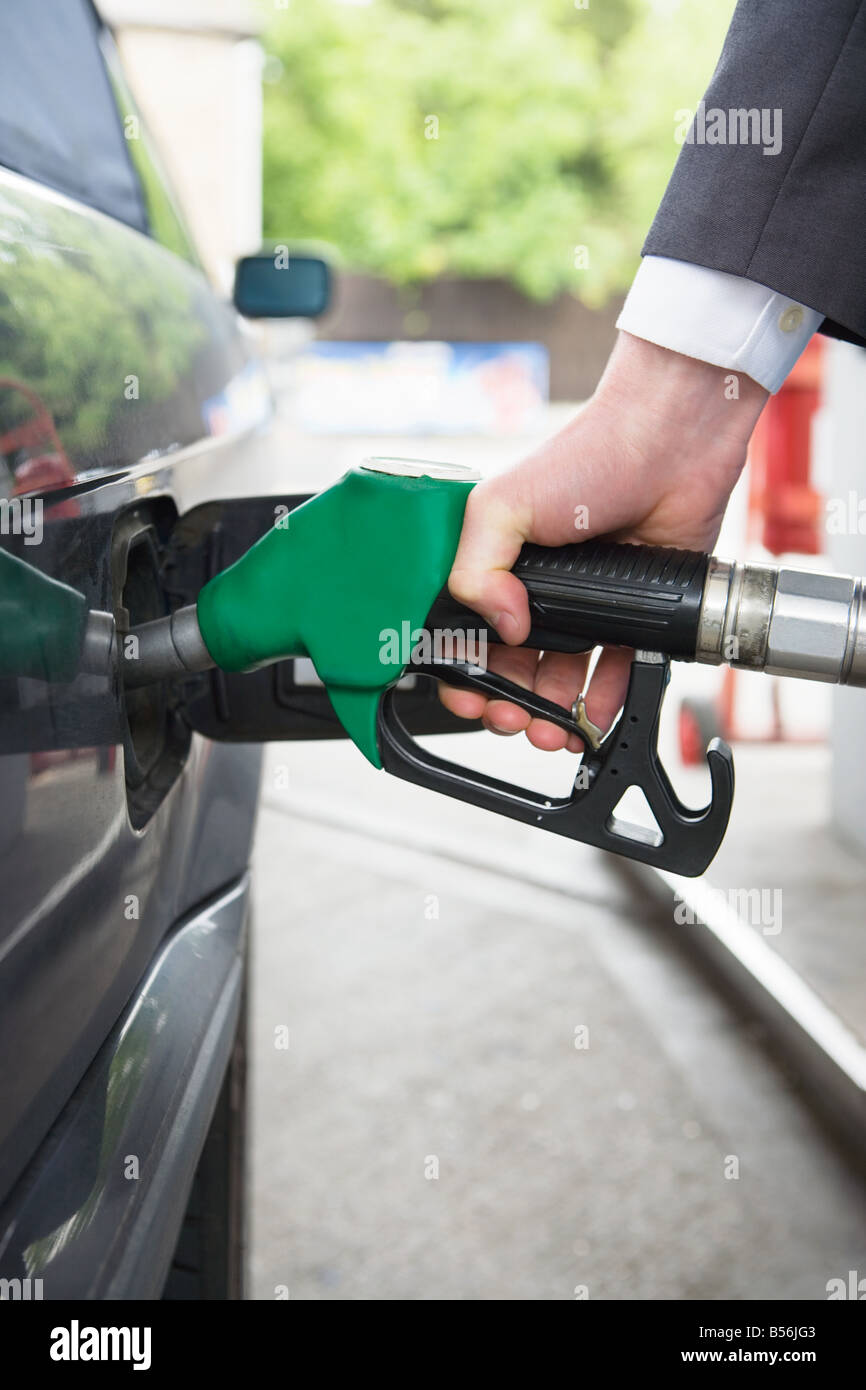A man filling a car with petrol Stock Photo - Alamy