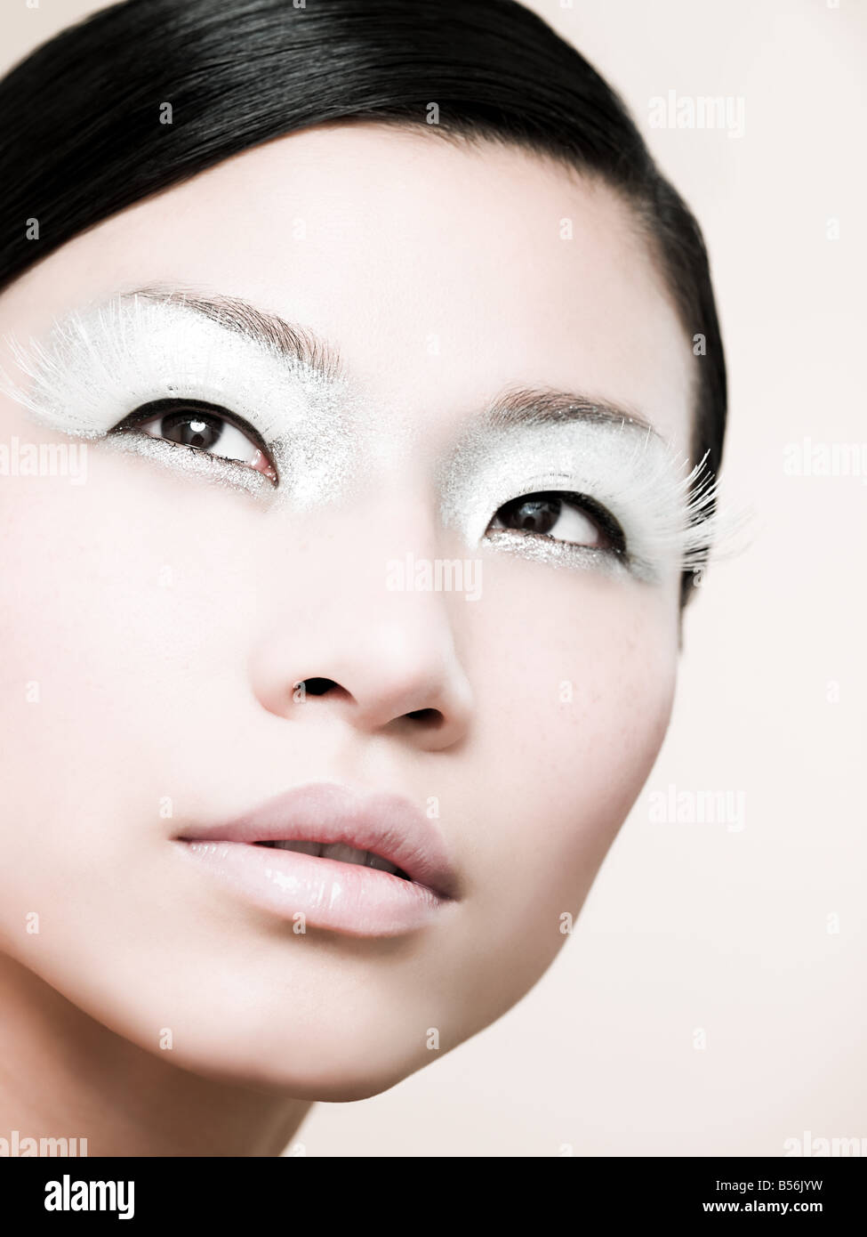 A young woman wearing a false eyelash Stock Photo - Alamy