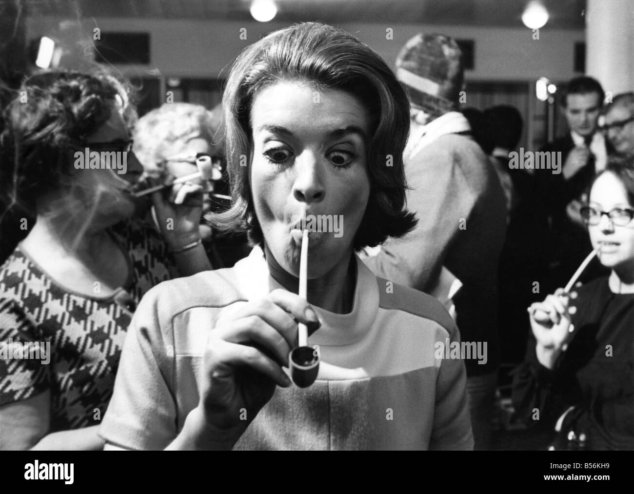 Blonde 28-year-old Jane Lumby experiments with her first pipe smoke at ...