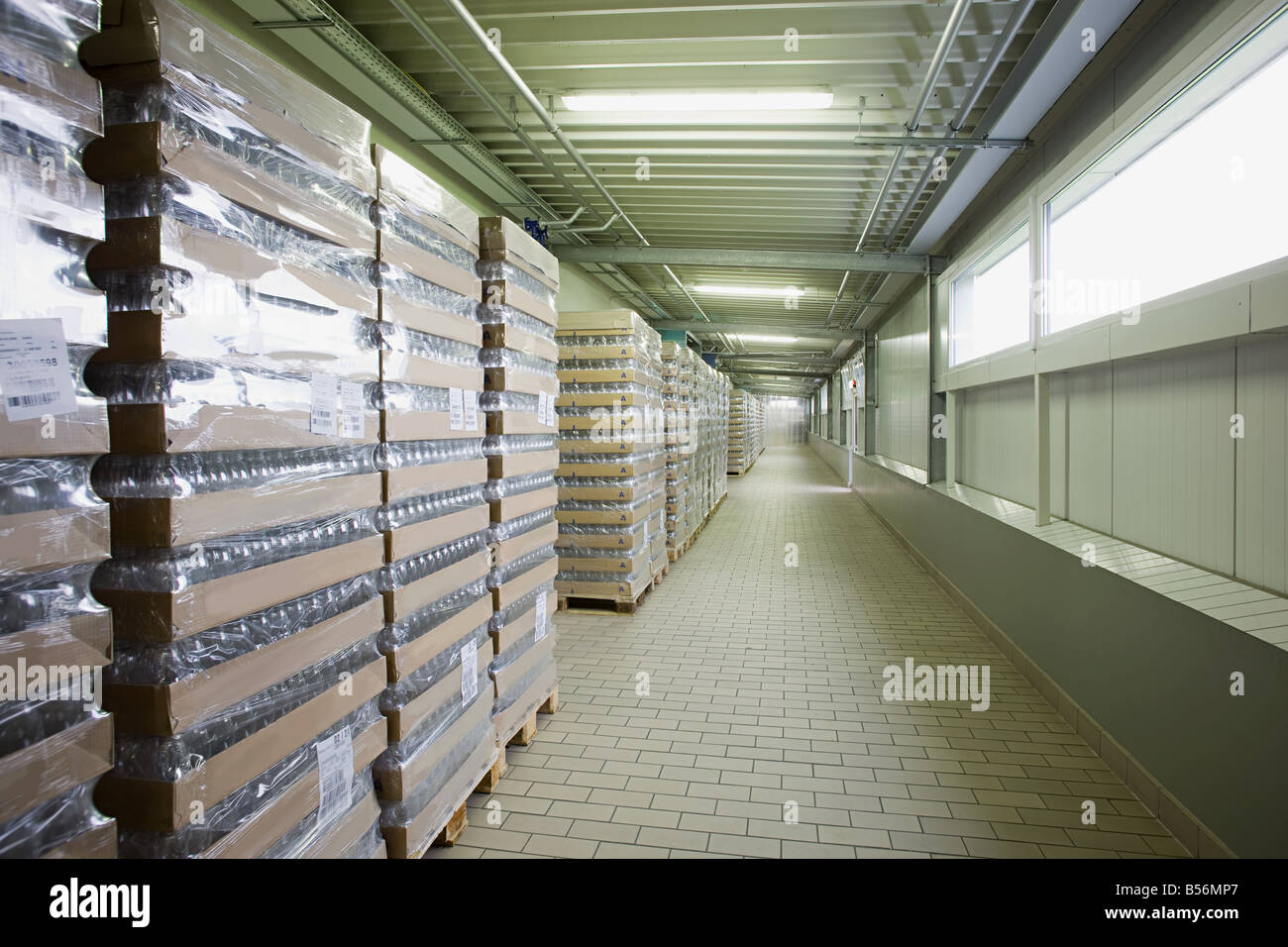 Row of stock pallets in a warehouse Stock Photo - Alamy