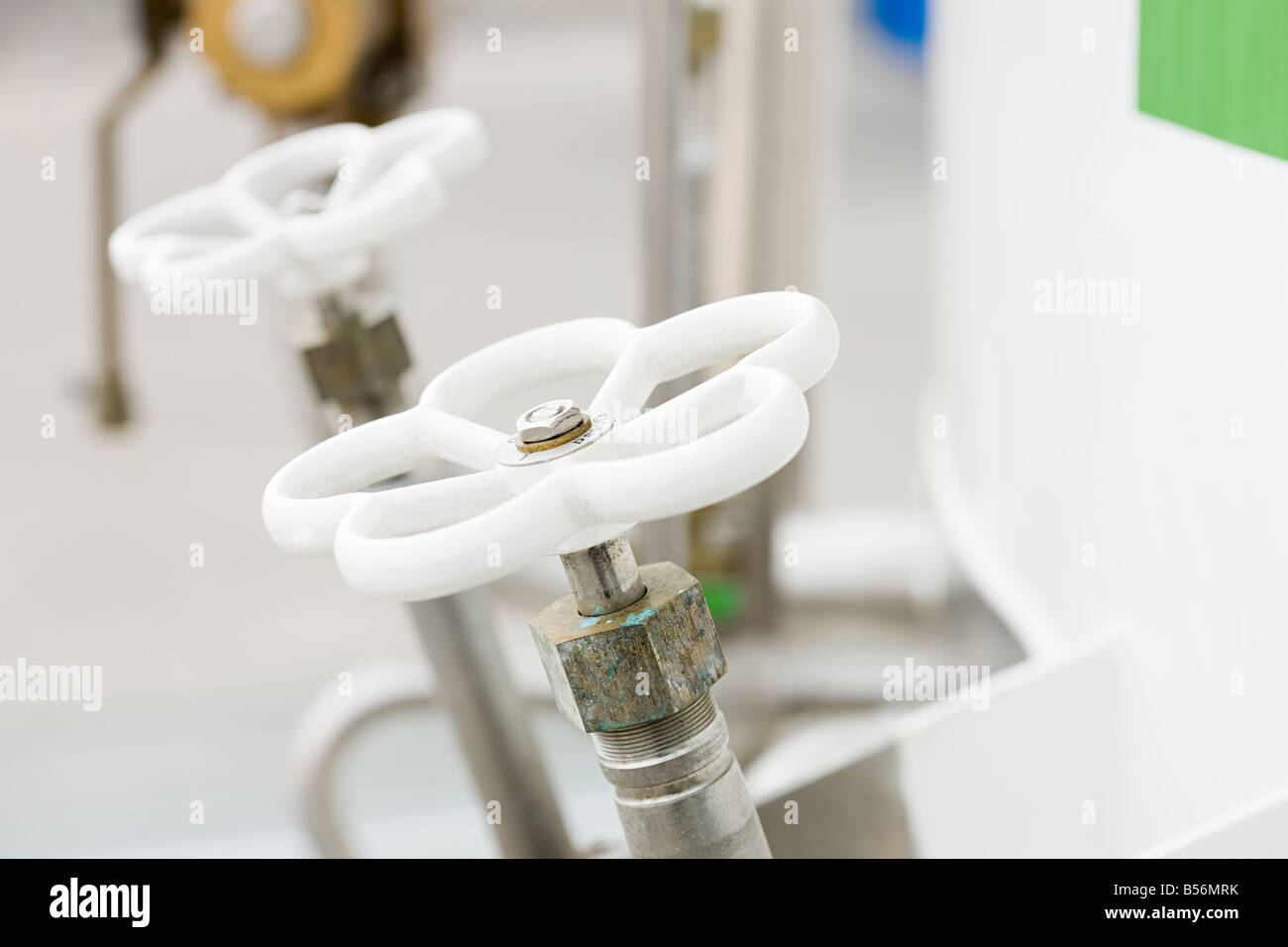 White handles on machinery Stock Photo - Alamy