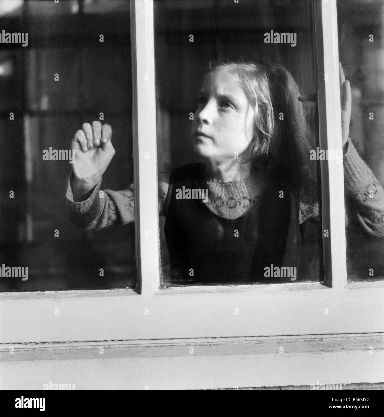 Children. Orphan girl looking out of window. December 1953 D7311-001 ...