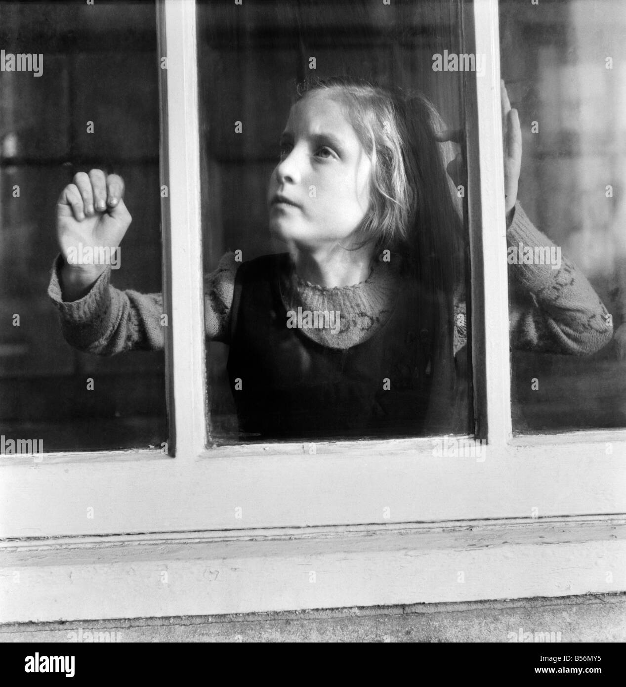 Children. Orphan girl looking out of window. December 1953 D7311-002 ...