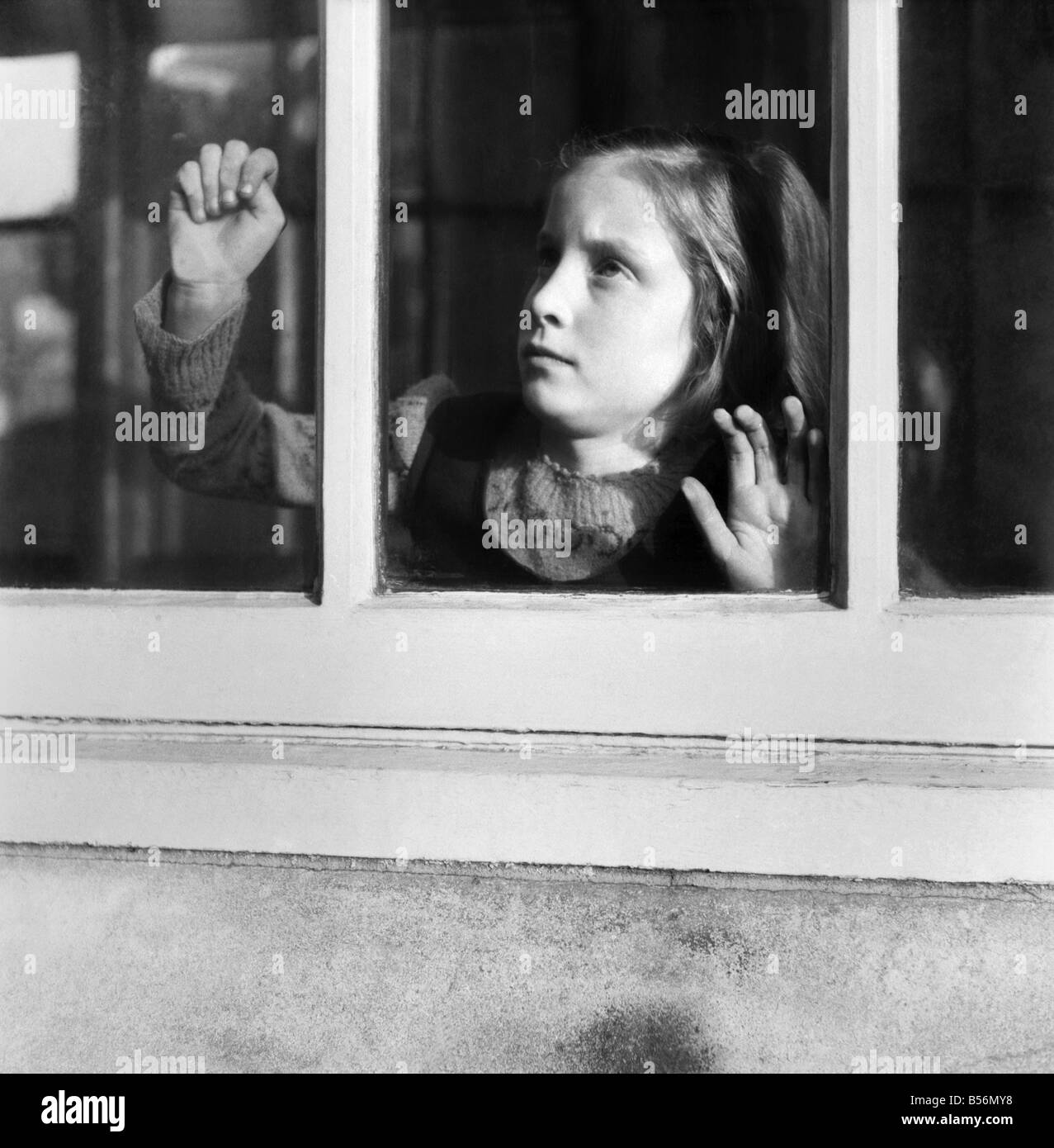 Children. Orphan girl looking out of window. December 1953 D7311-003 ...