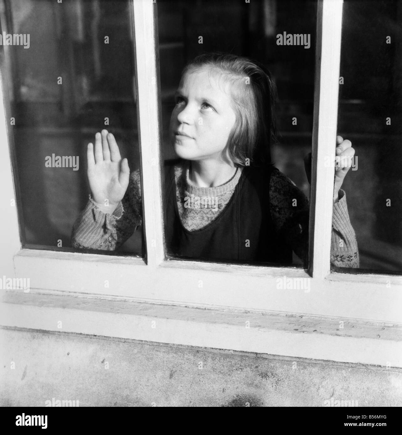 Children. Orphan girl looking out of window. December 1953 D7311 Stock ...