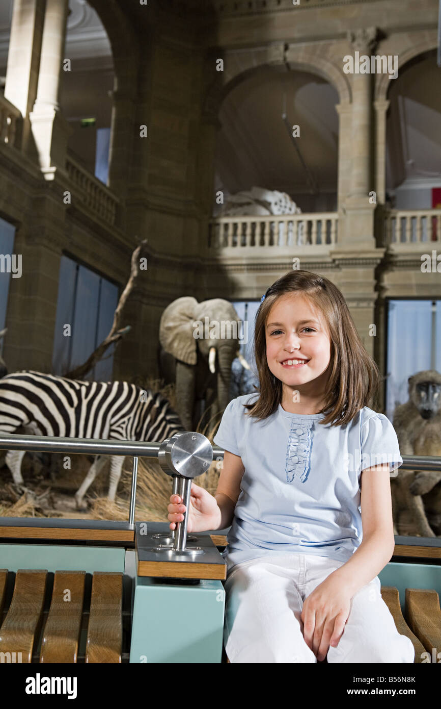 Girl sitting in a museum Stock Photo - Alamy