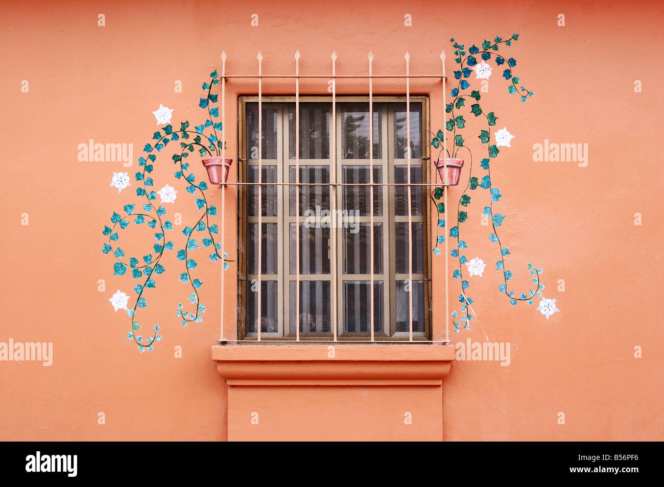 A barred window decorated with hand painting on a casa in Ajijic Mexico ...