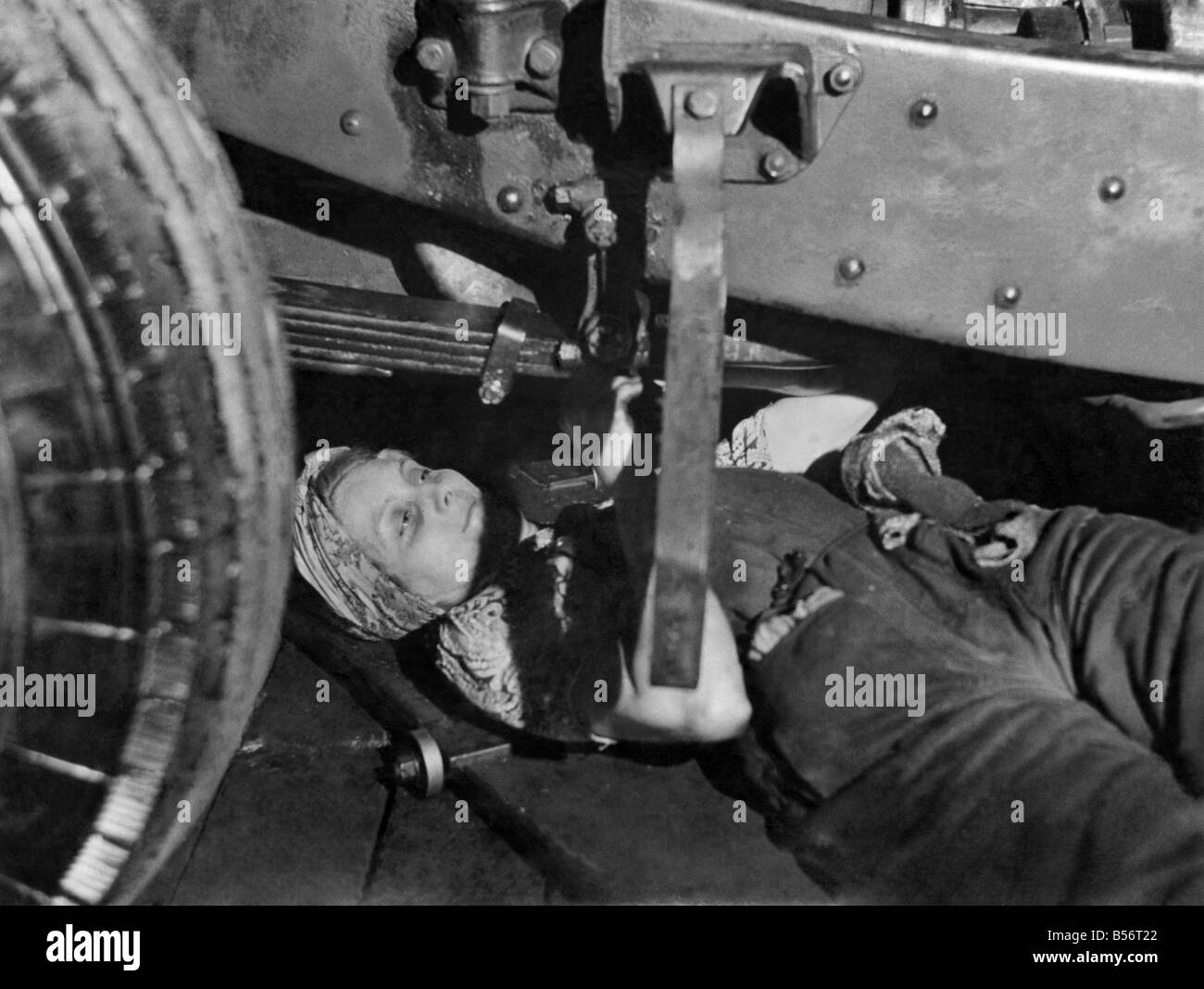 A women bus mechanic at work underneath the vehicle. June 1941 P010117 ...