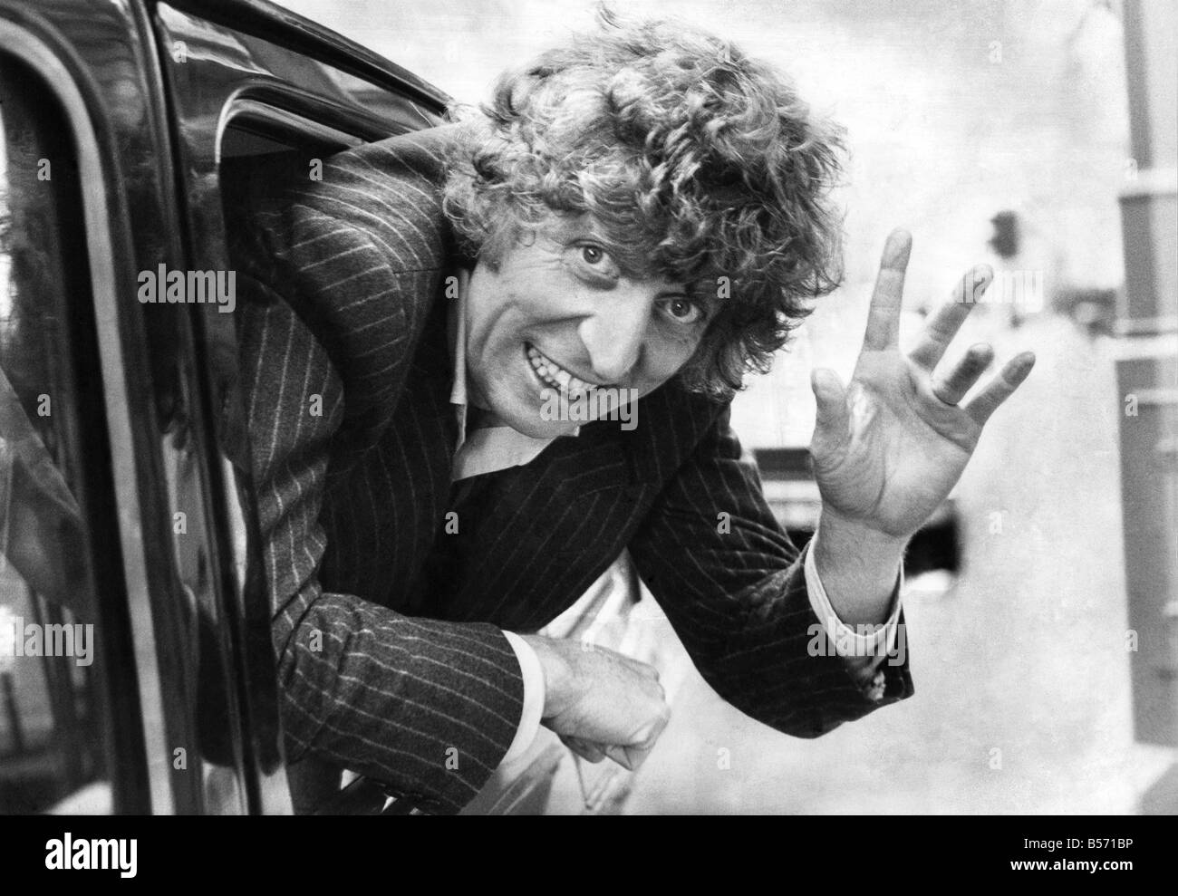 English actor Tom Baker waving from the back of a taxi. October 1980 ...