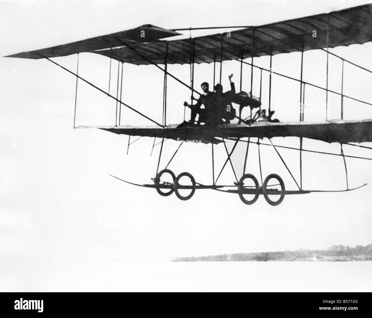 French aviator Henry Farman flying in his plane with two passengers ...
