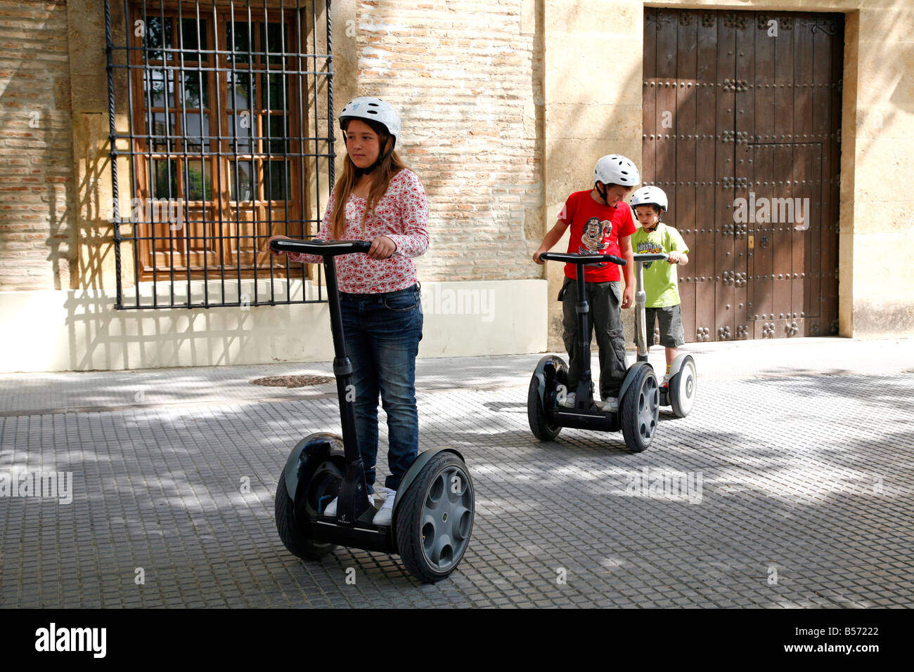Children using Segways on a tourist route in Cordoba, Andalucia Spain ...