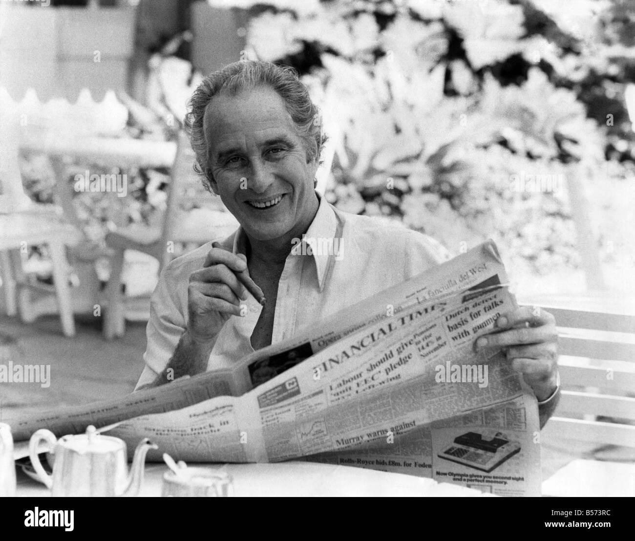The confident smile, elegant cigar and significant reading matter ...