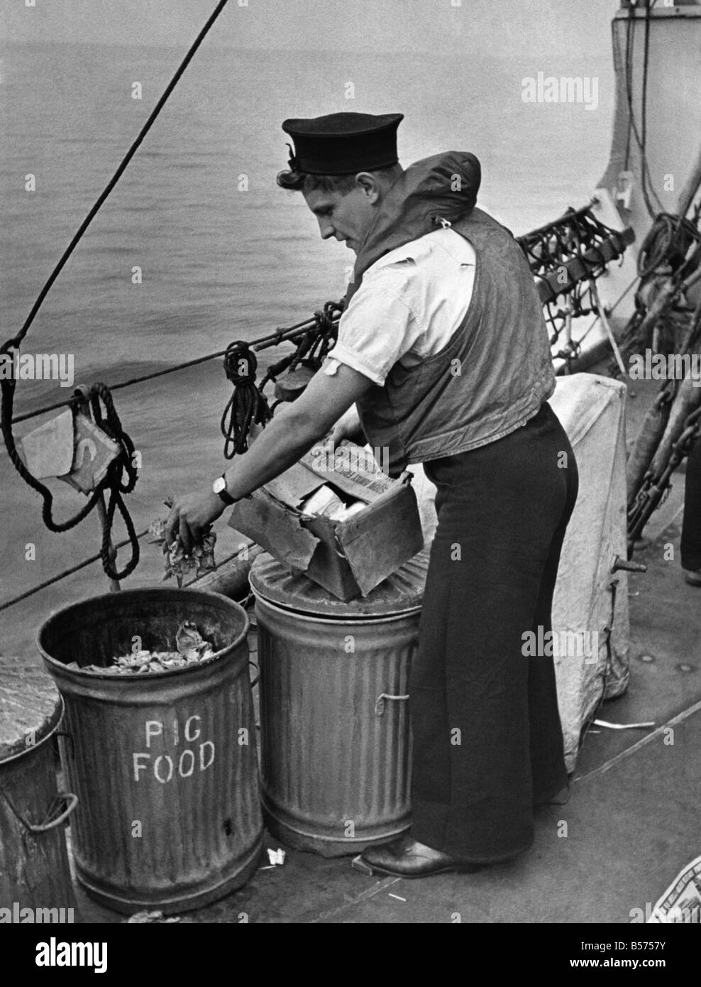 Nothing to wasted at sea. Seaman placing waste in salvage tins so ...