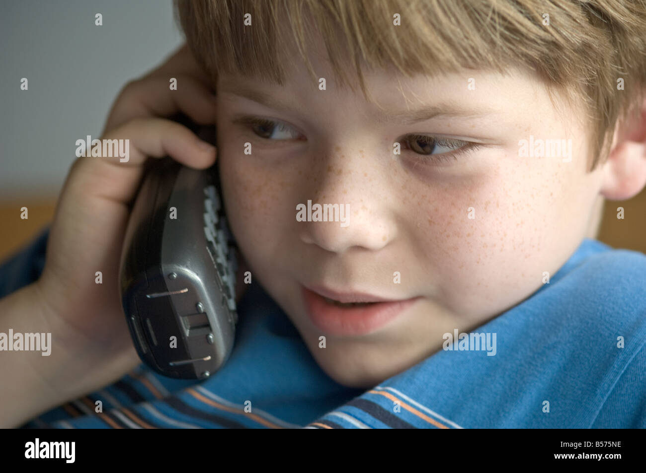 Young boy talking on cordless Phone Stock Photo - Alamy