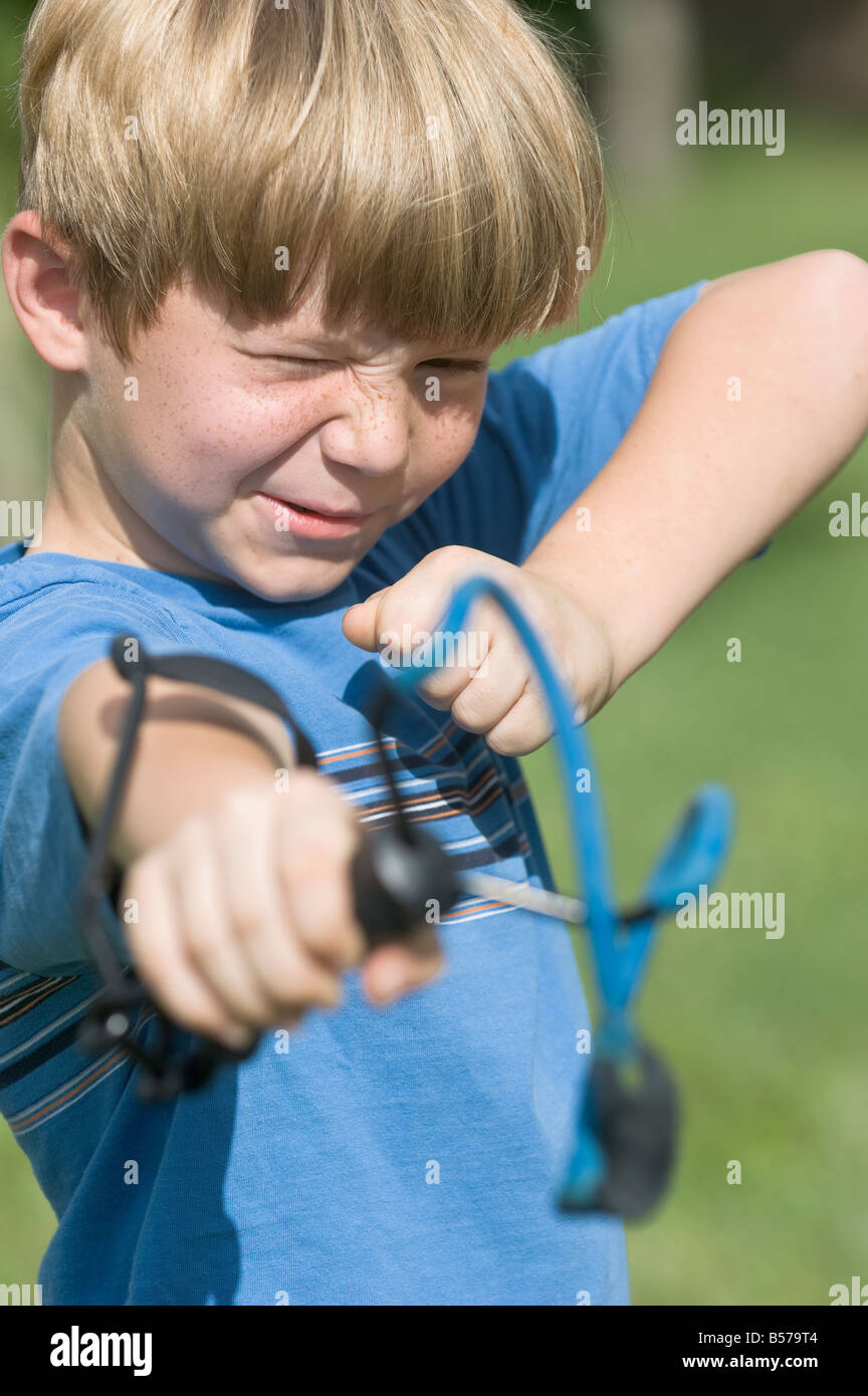 Young boy with slingshot Stock Photo - Alamy