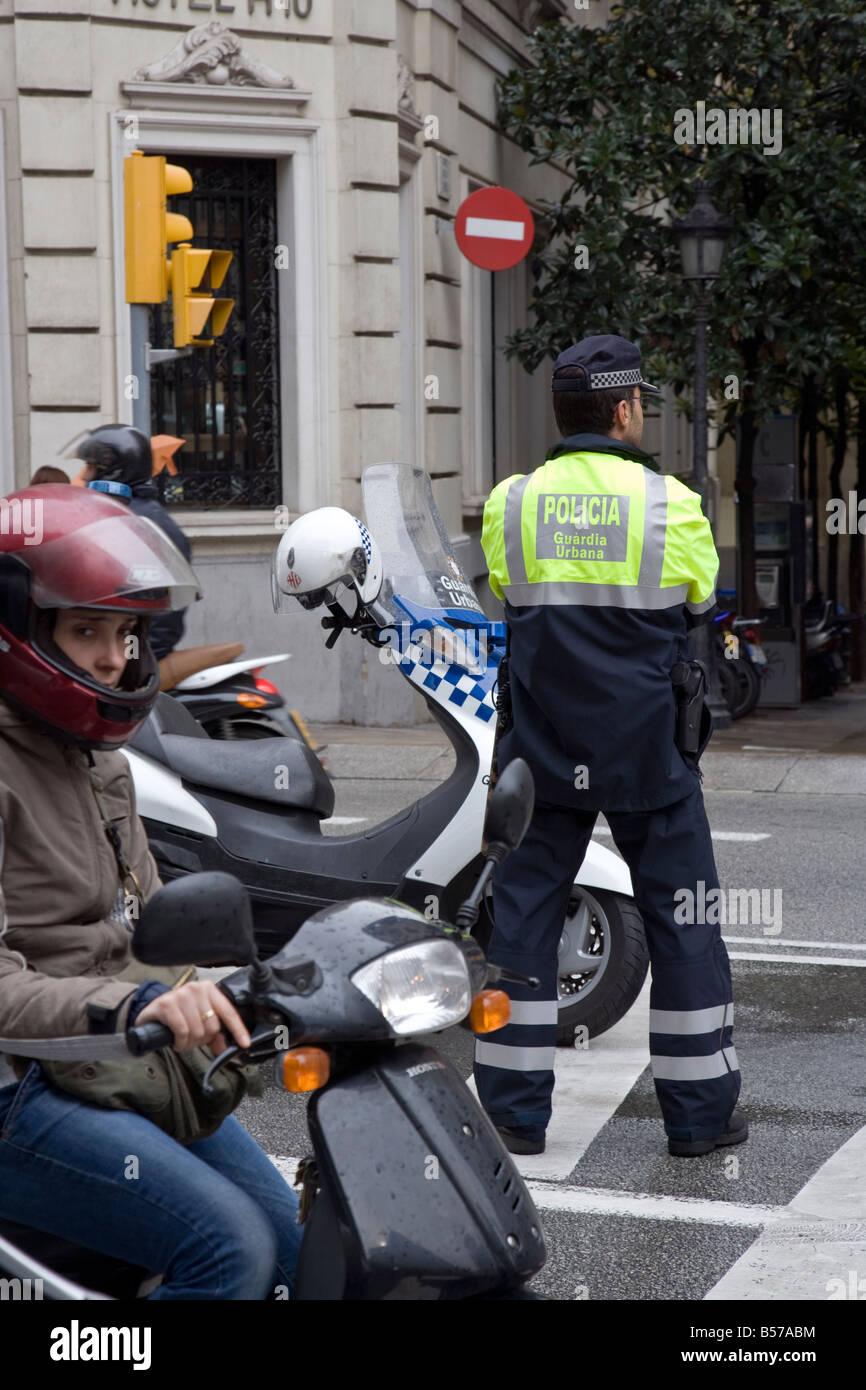 A spanish policeman policia guardia urbana directing traffic on Via ...