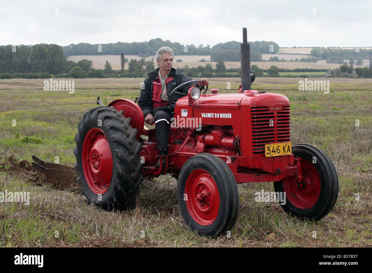 A vintage Valmet 33 Diesel tractor with a plough attached in a field in ...