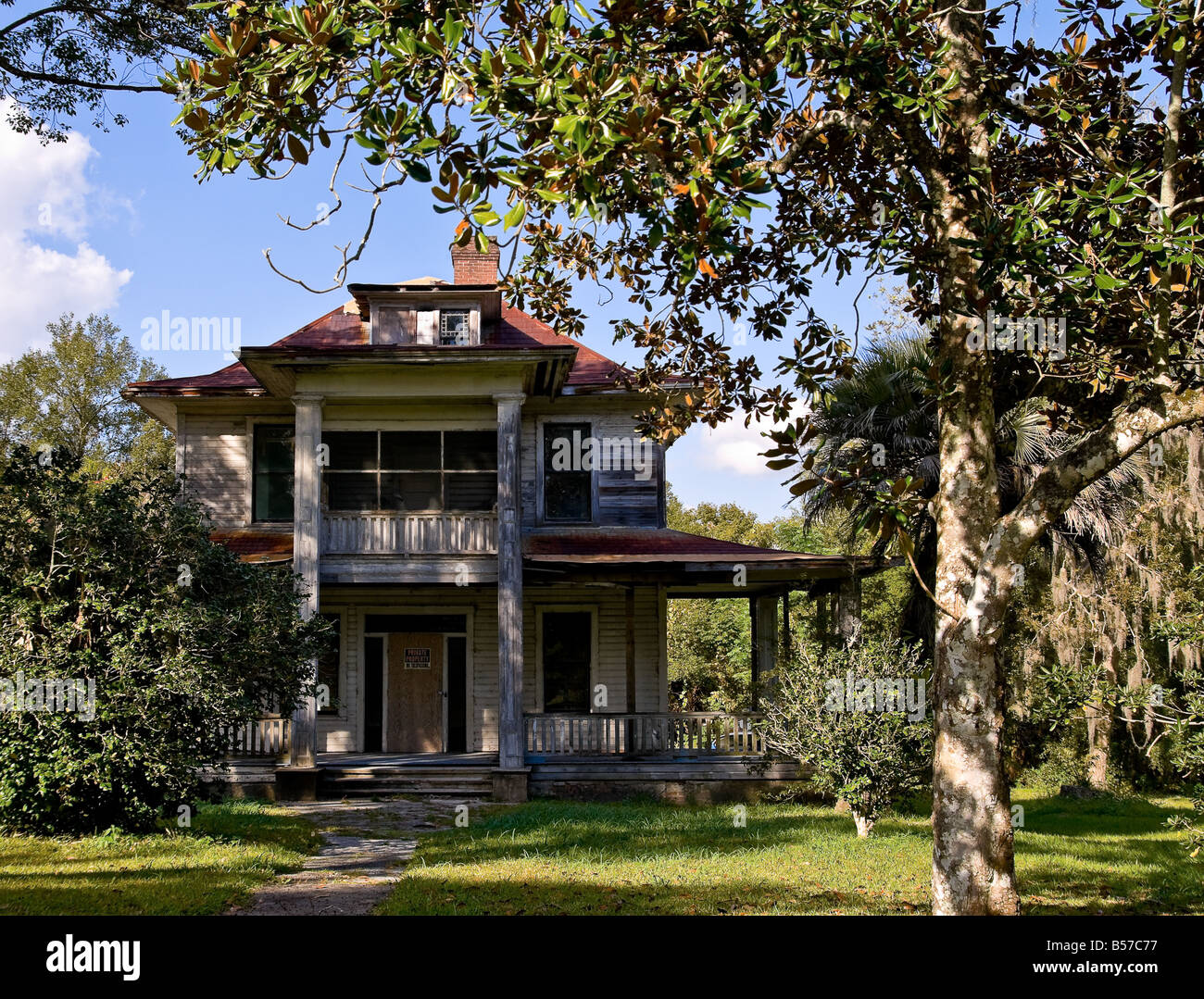 Weathered old house with front door boarded up and locked Stock Photo ...