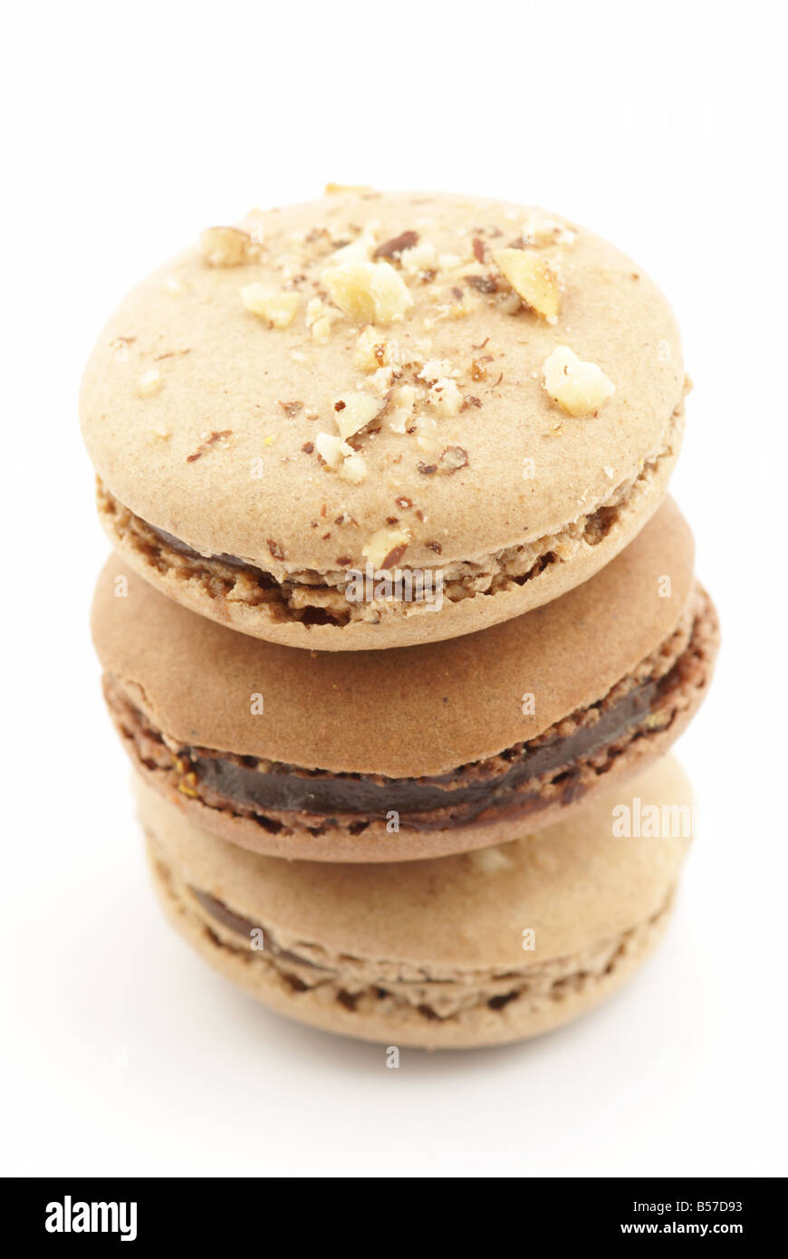 three chocolate and praliné nuts macaroons on a white background (cut ...