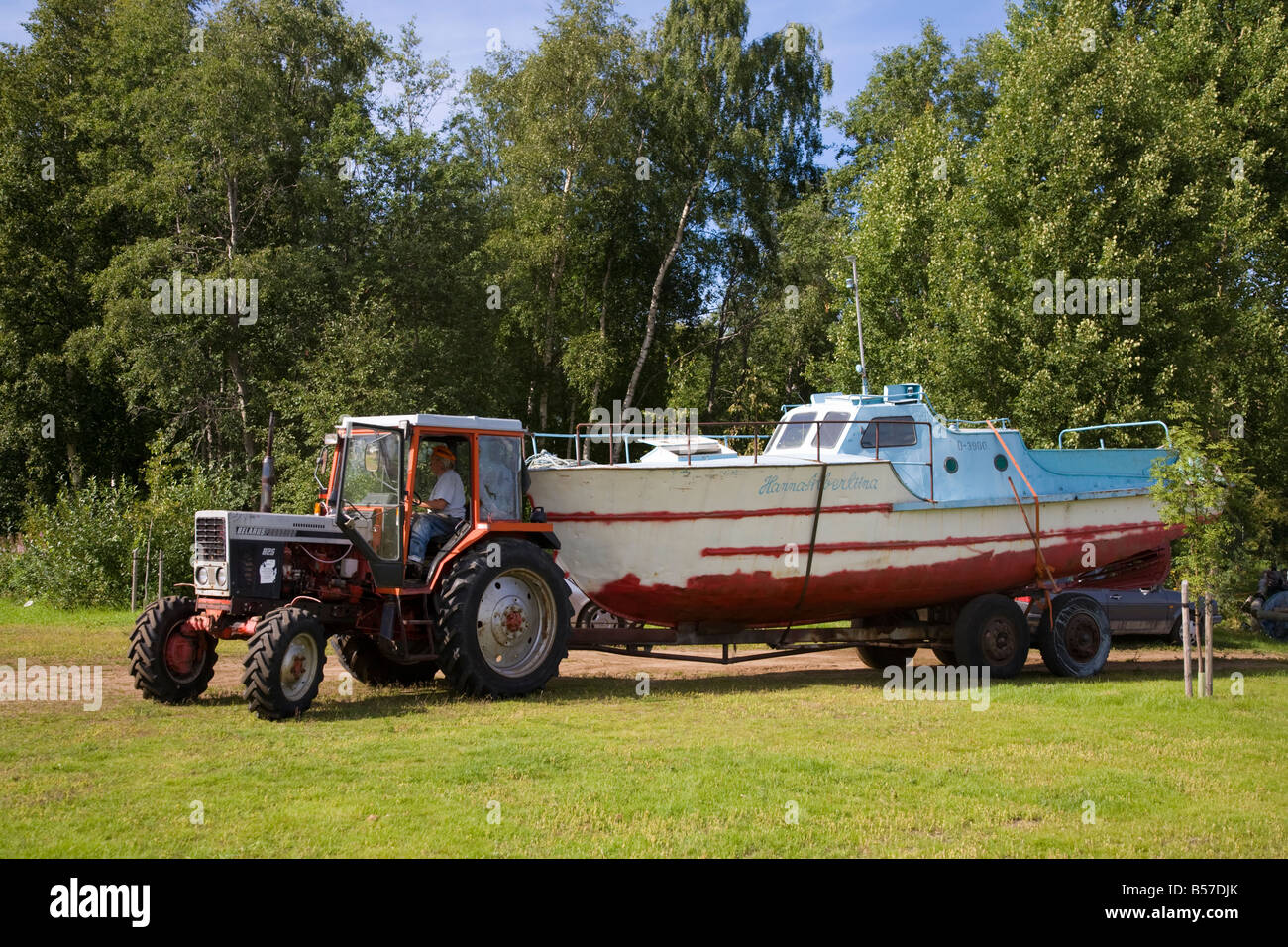Transporting a motorboat using tractor and boat trailer , Finland Stock ...