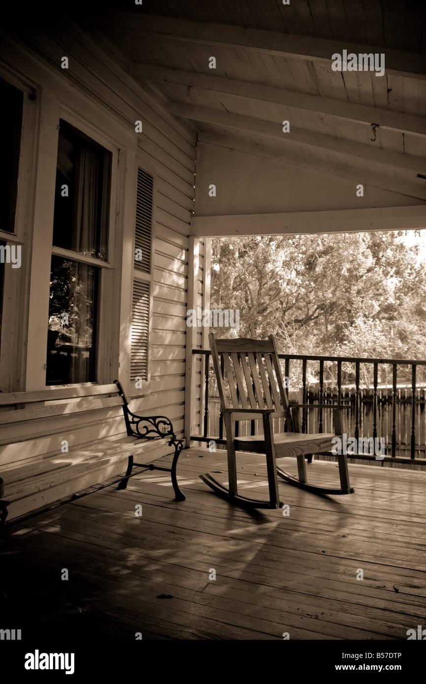 Sepia toned old time country porch with rocking chair and bench Stock ...