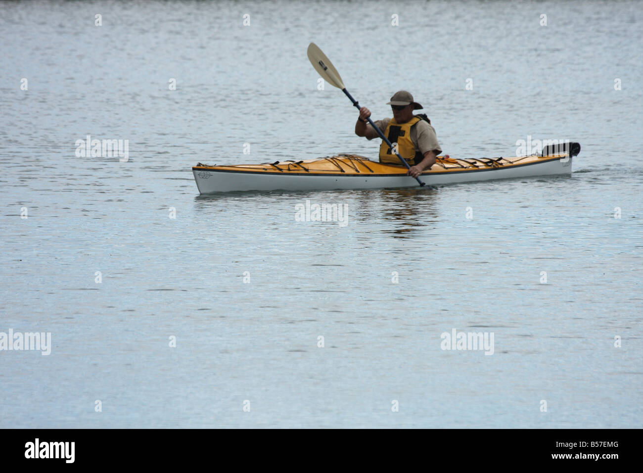 A male Kayaker kayaking in the harbor of Milwaukee Wisconsin in summer ...