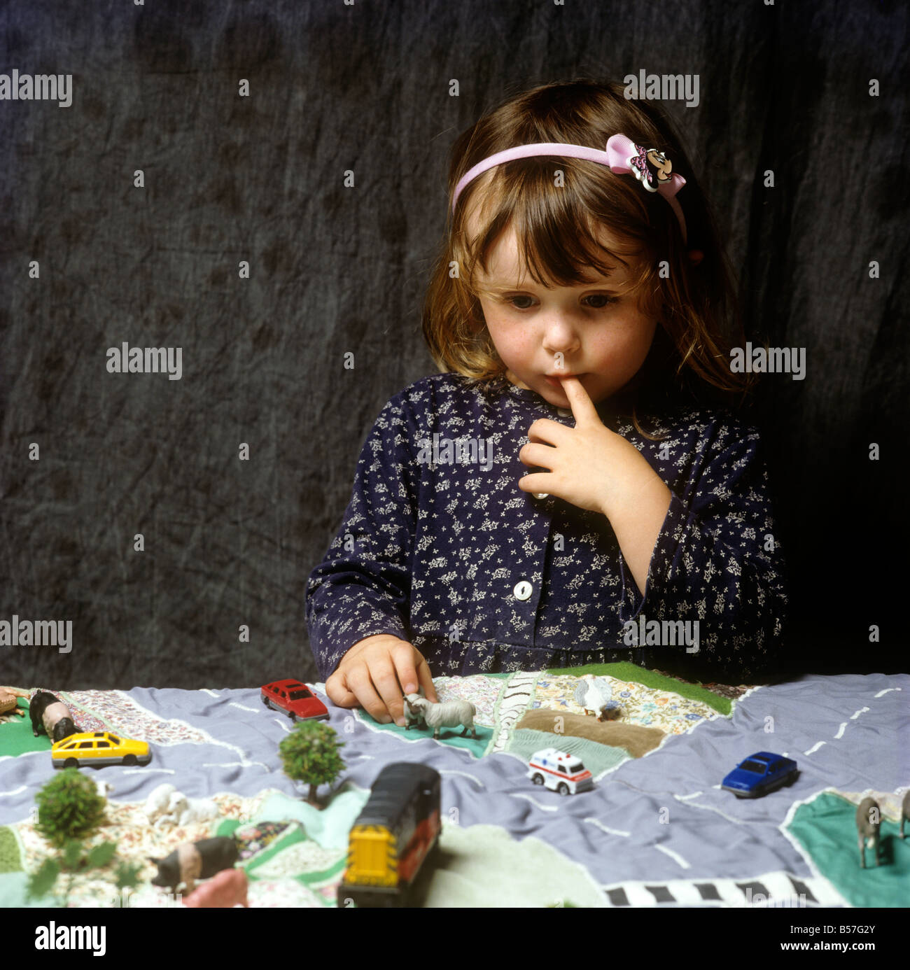 Crafts Child playing on applique map play mat Stock Photo - Alamy