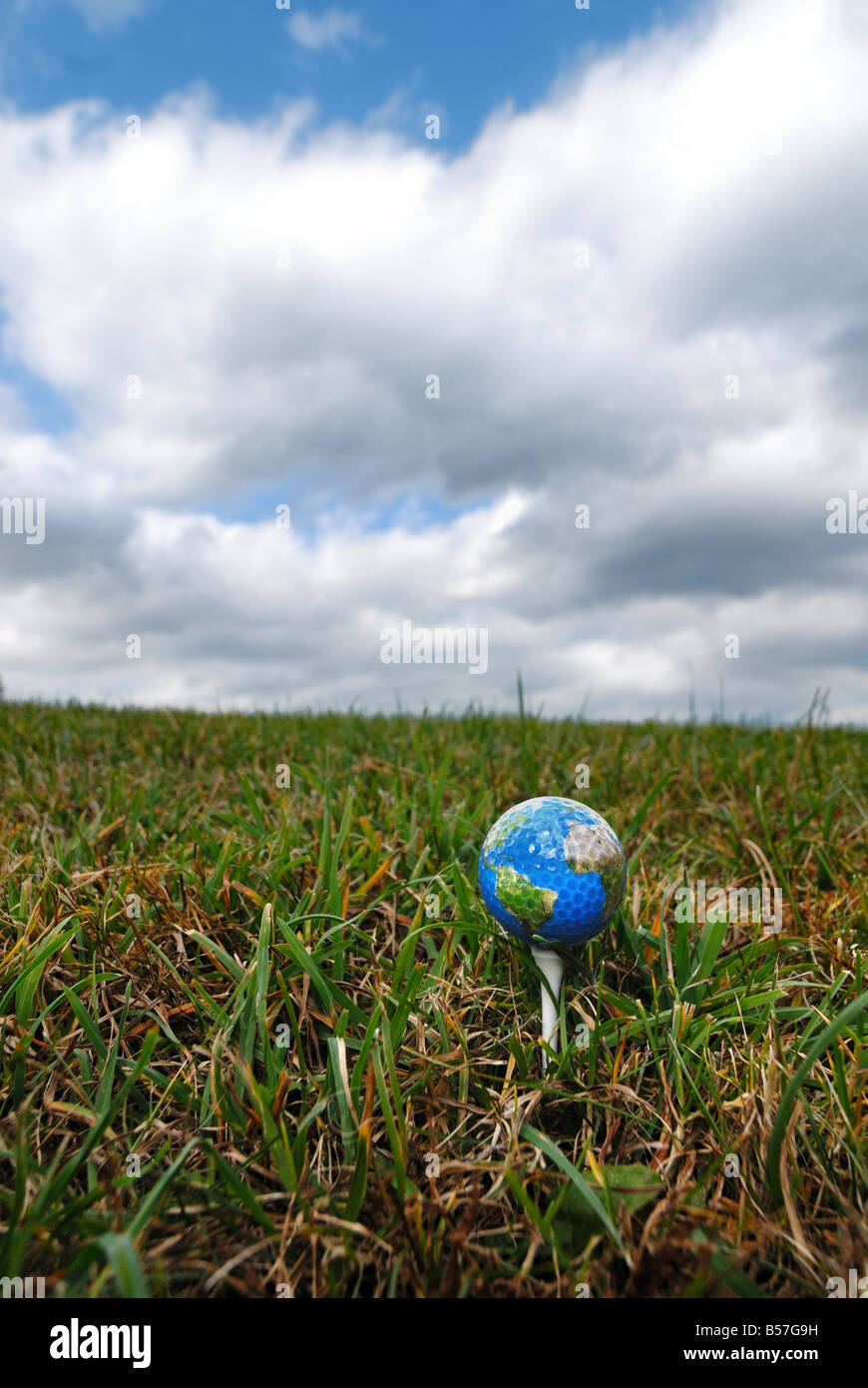 A golf ball depicting the earth sits on a golf tee Stock Photo - Alamy