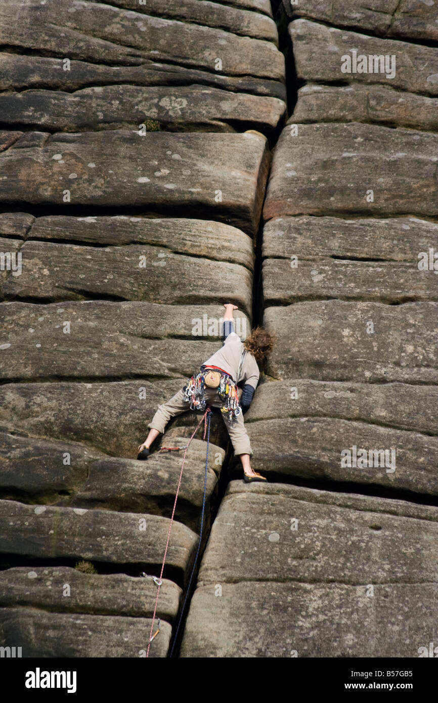 Climber climbing crack in rock Stock Photo - Alamy