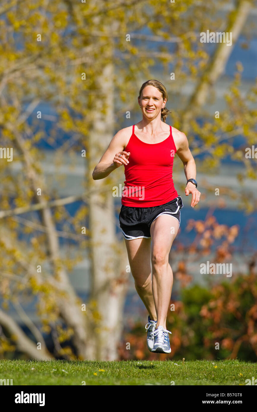 Early 30's Caucasian woman running in a park Stock Photo - Alamy