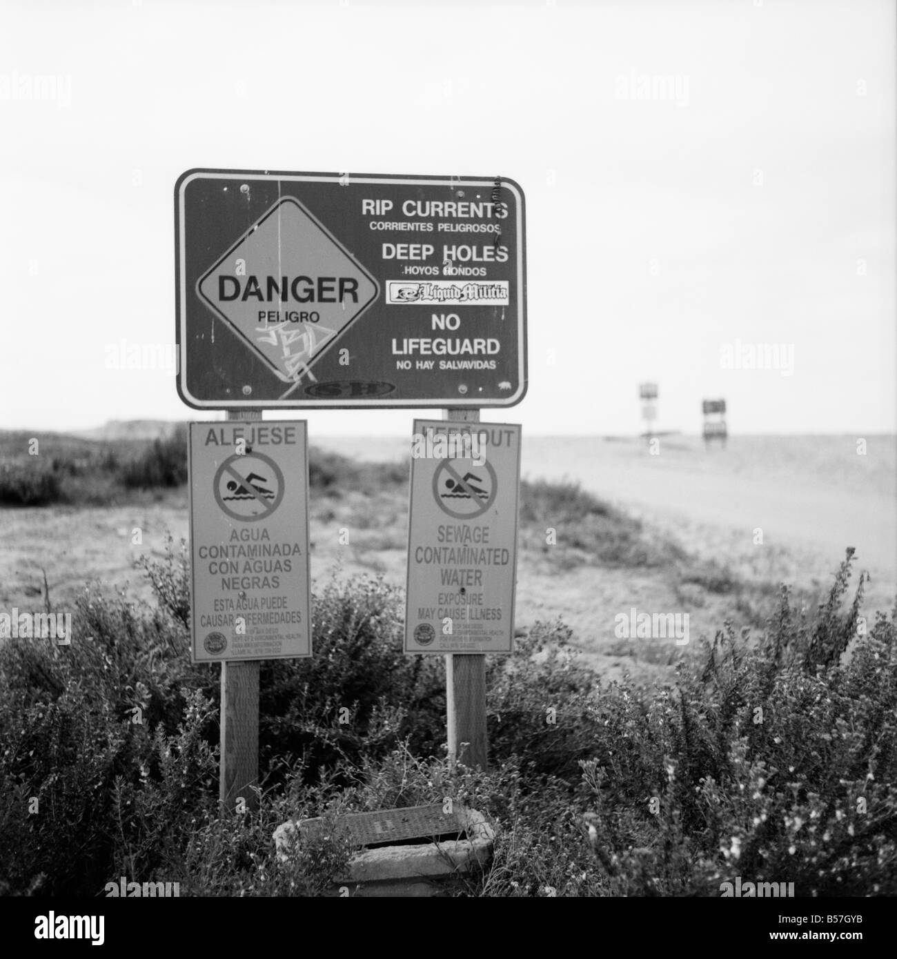 A danger sign warning of riptide currents and sewage contaminated water ...