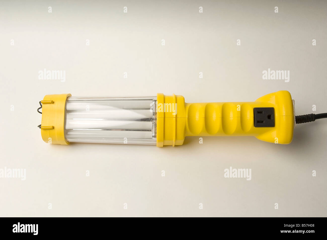 Fluorescent shop light or work light with a yellow plastic housing on a ...