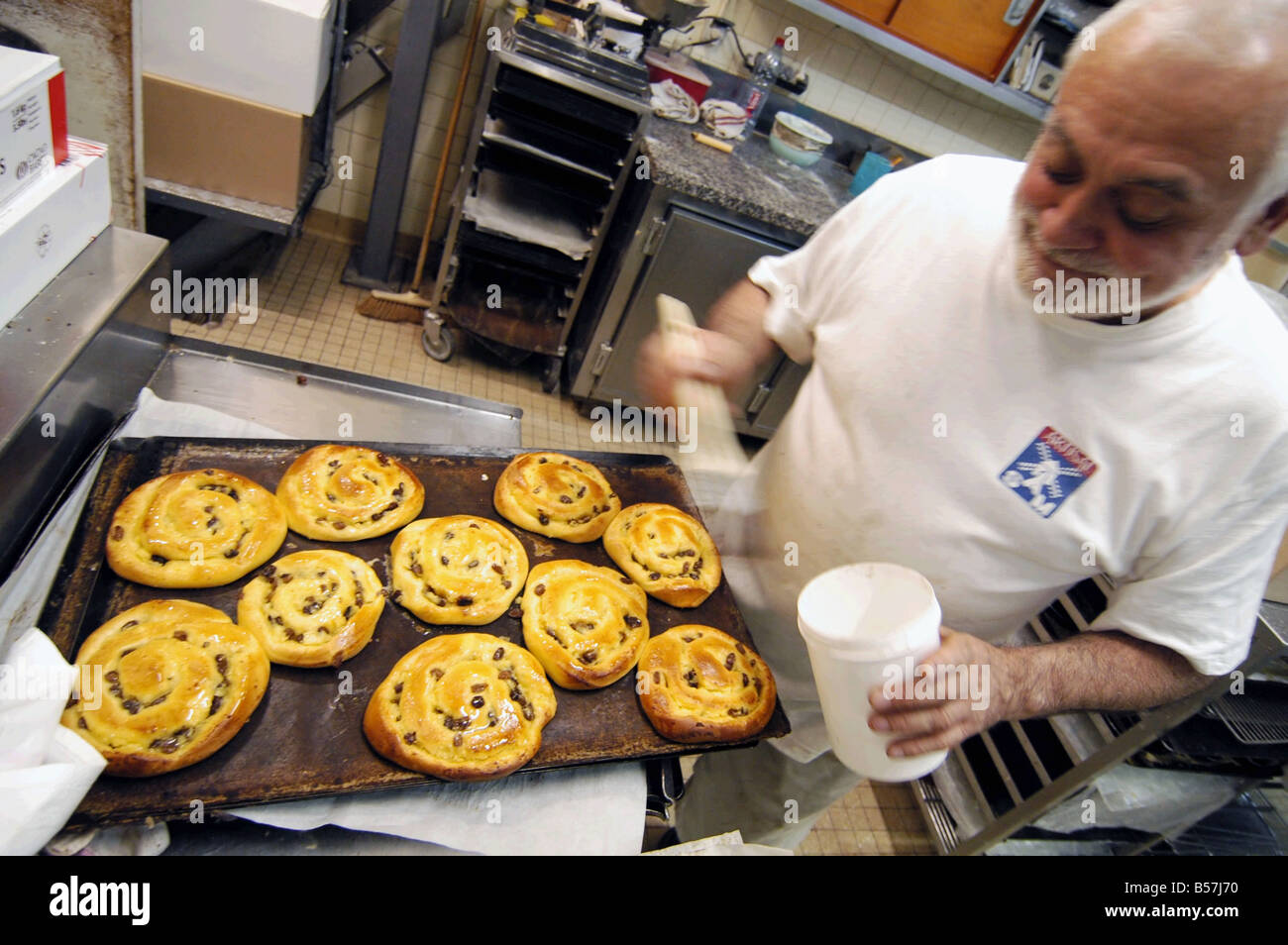 A French chef at work in his bakery, making croissants and other ...