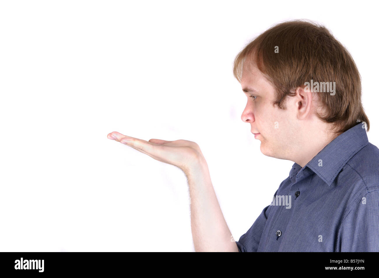 Young man looking at something surprising on his hand Stock Photo - Alamy
