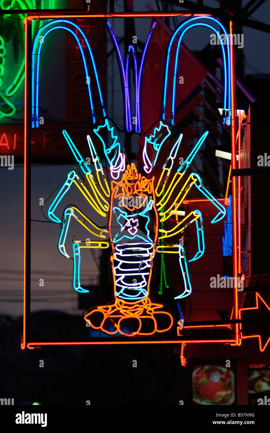Neon lobster outside a seafood restaurant in the walking street a ...