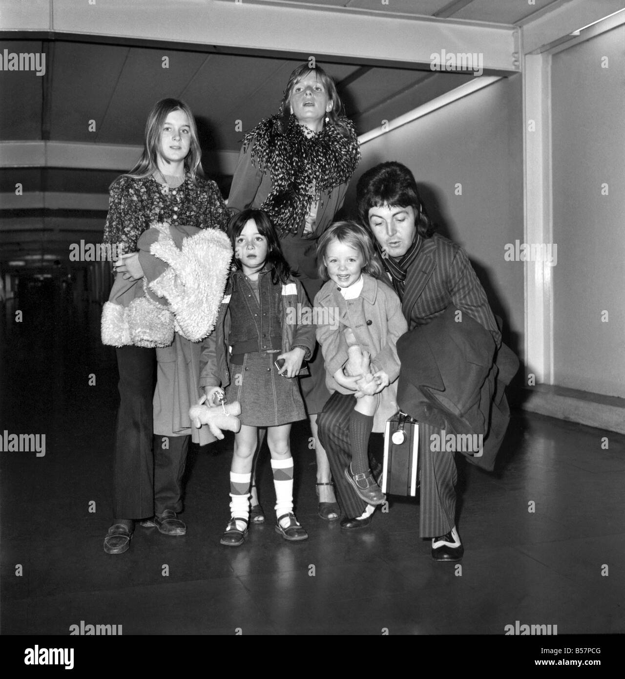 Pop star Paul McCartney and family. Carrying a portable radio, ex ...