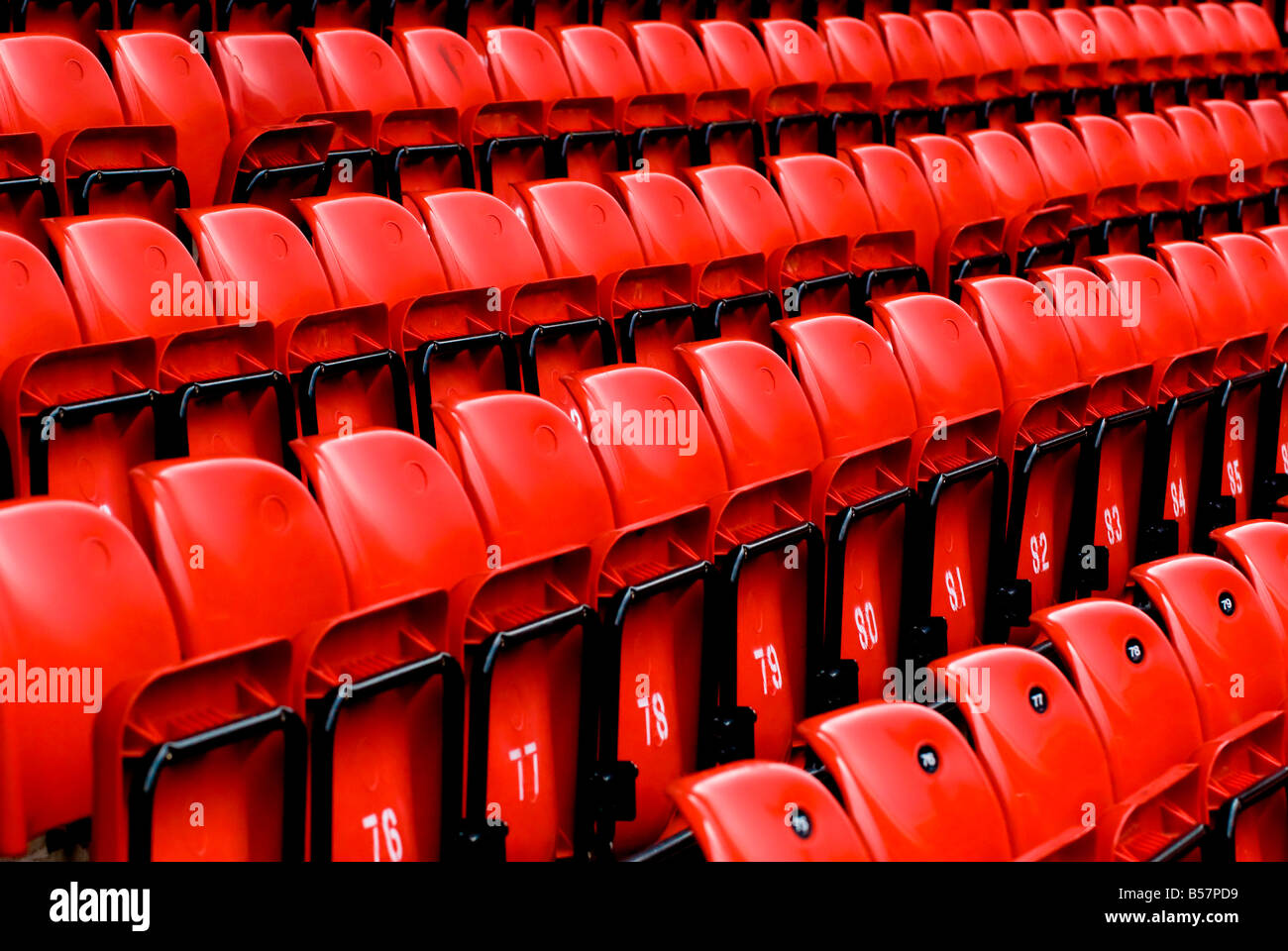 Bright red stadium seats Stock Photo - Alamy