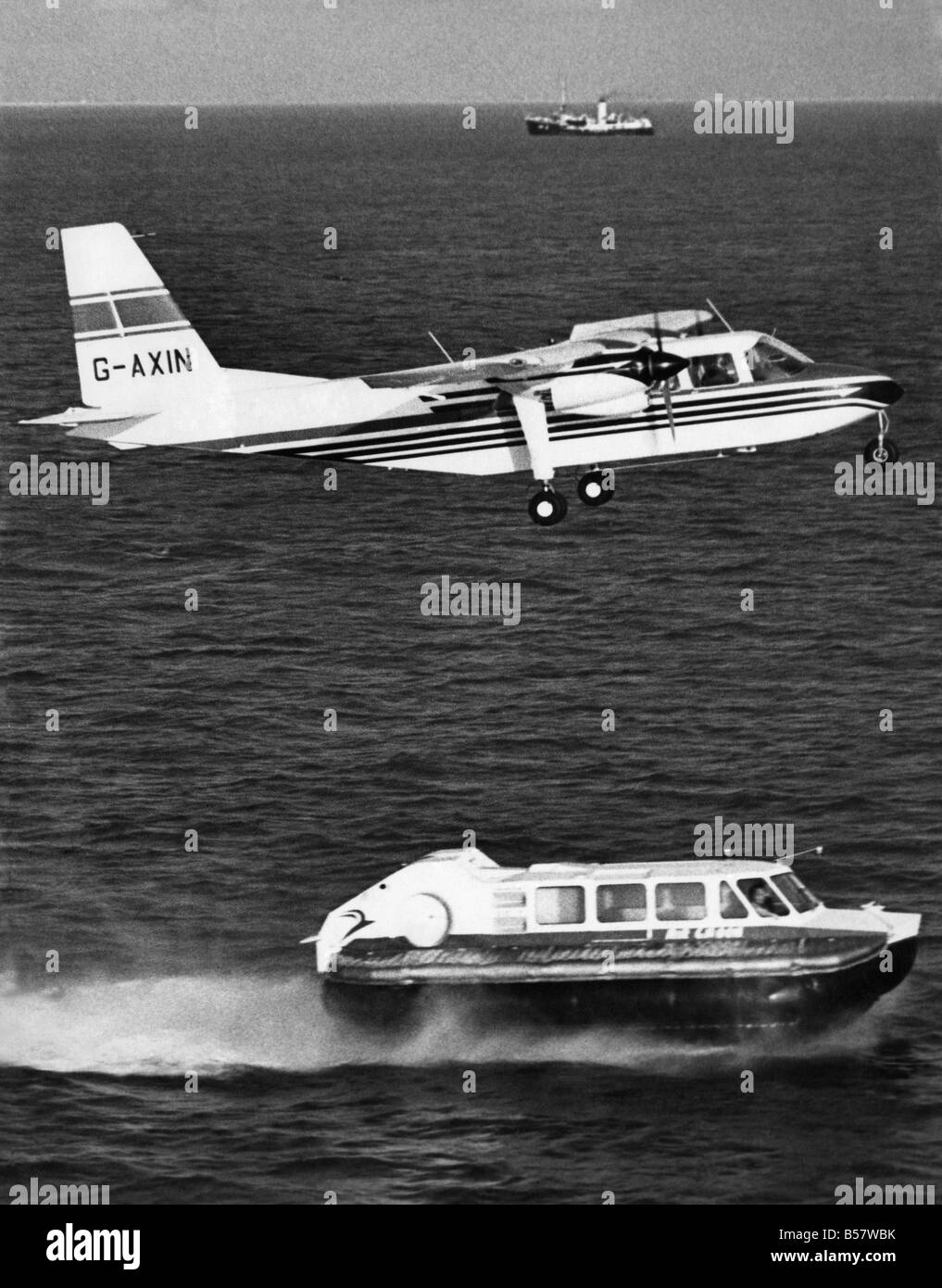 A Britten Norman Islander aircraft flies over a Cushion Craft ...