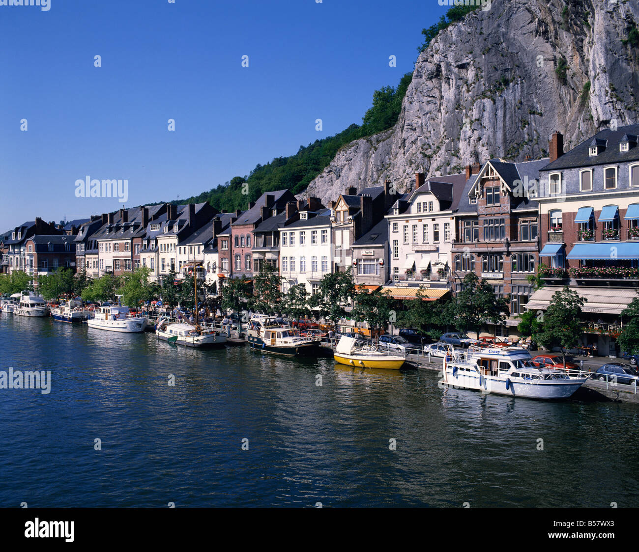 Boats line the waterfront on the River Meuse in the old town of Dinant ...