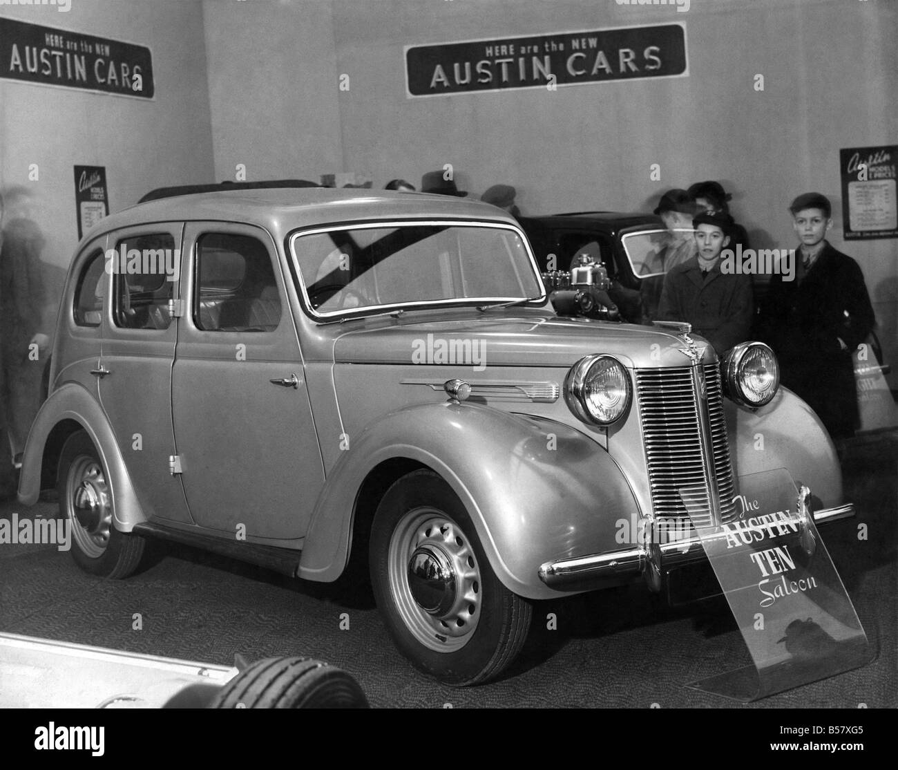 Customers looking at an Austin A10 car in a showroom. January 1946 ...