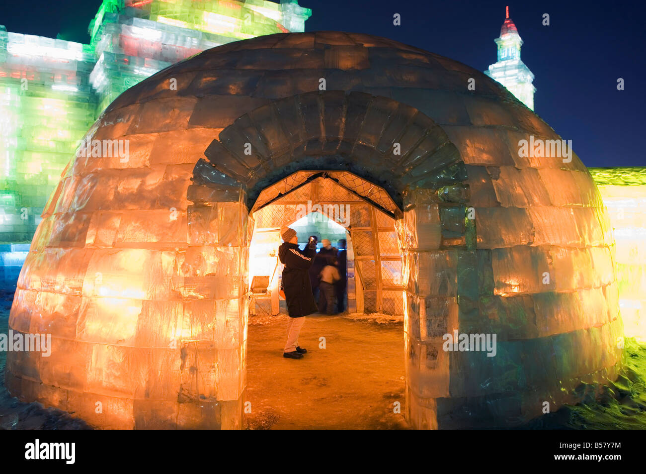 An igloo ice sculpture illuminated at night at the Ice Lantern Festival ...