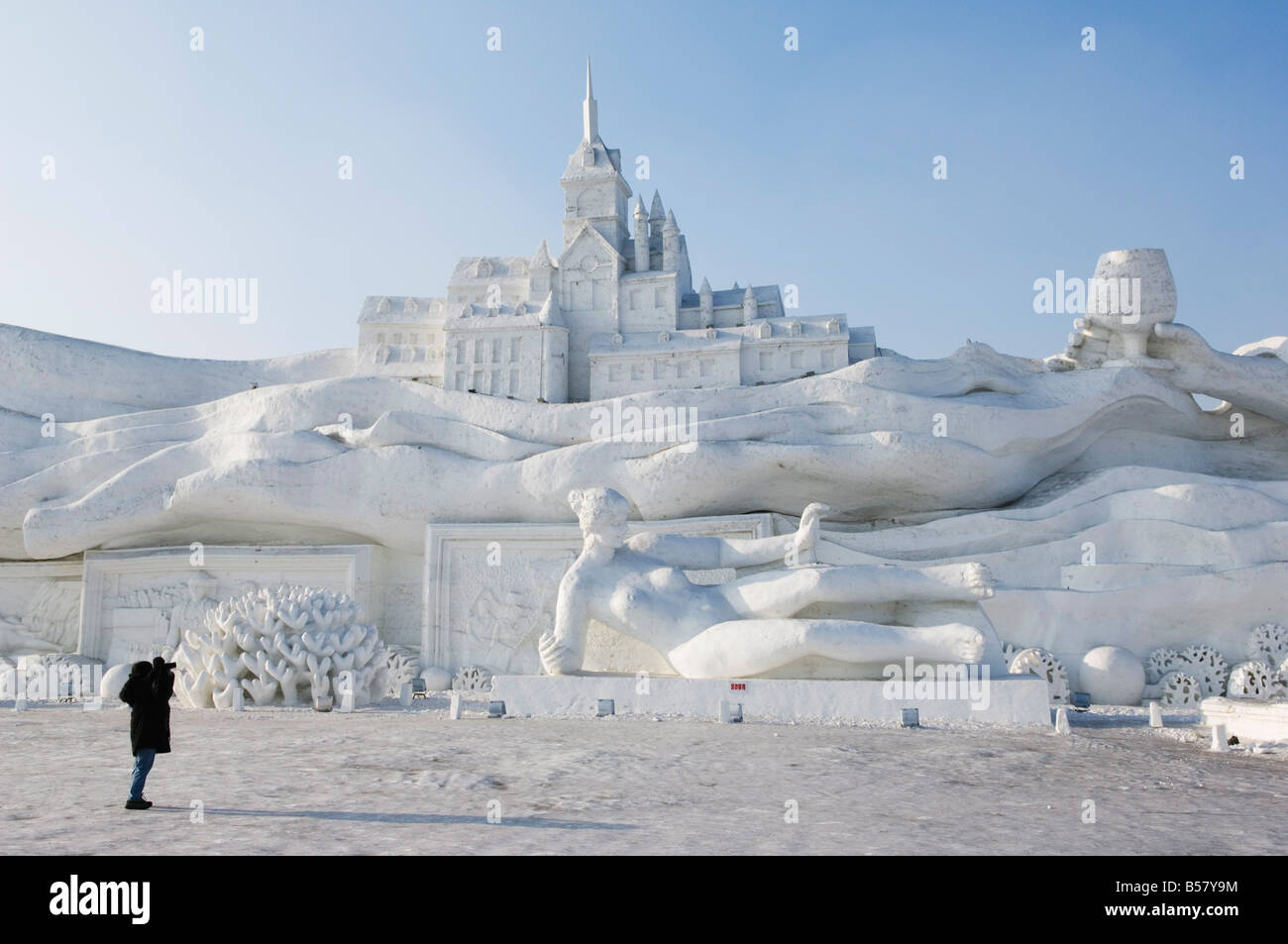 Person photographing a giant sculpture at Snow and Ice Sculpture ...