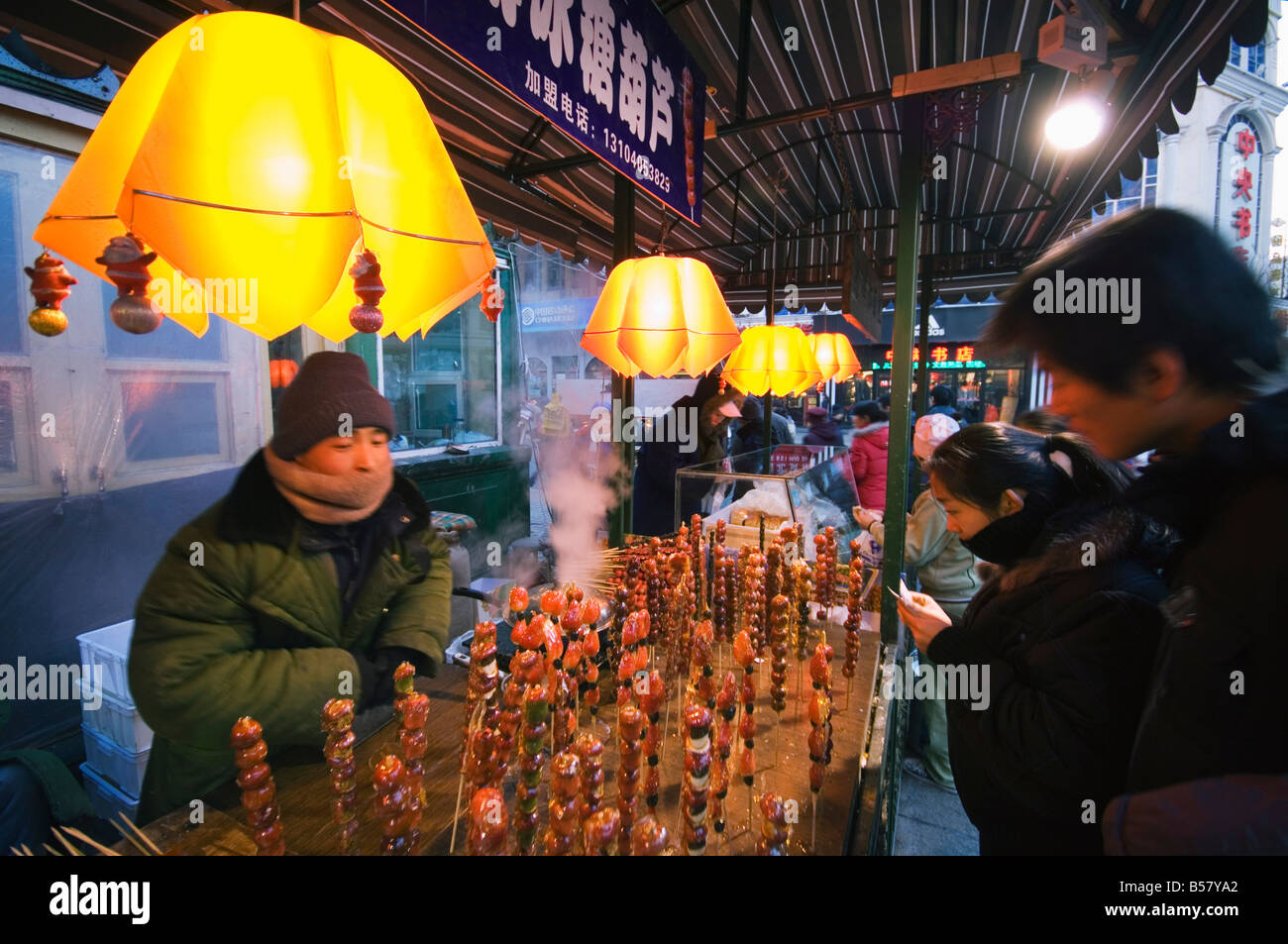 A street market selling local snacks and sweet hawthorne on sticks ...