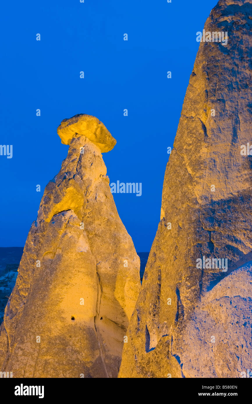 Fairy chimneys known as The Three Beauties illuminated at night near ...