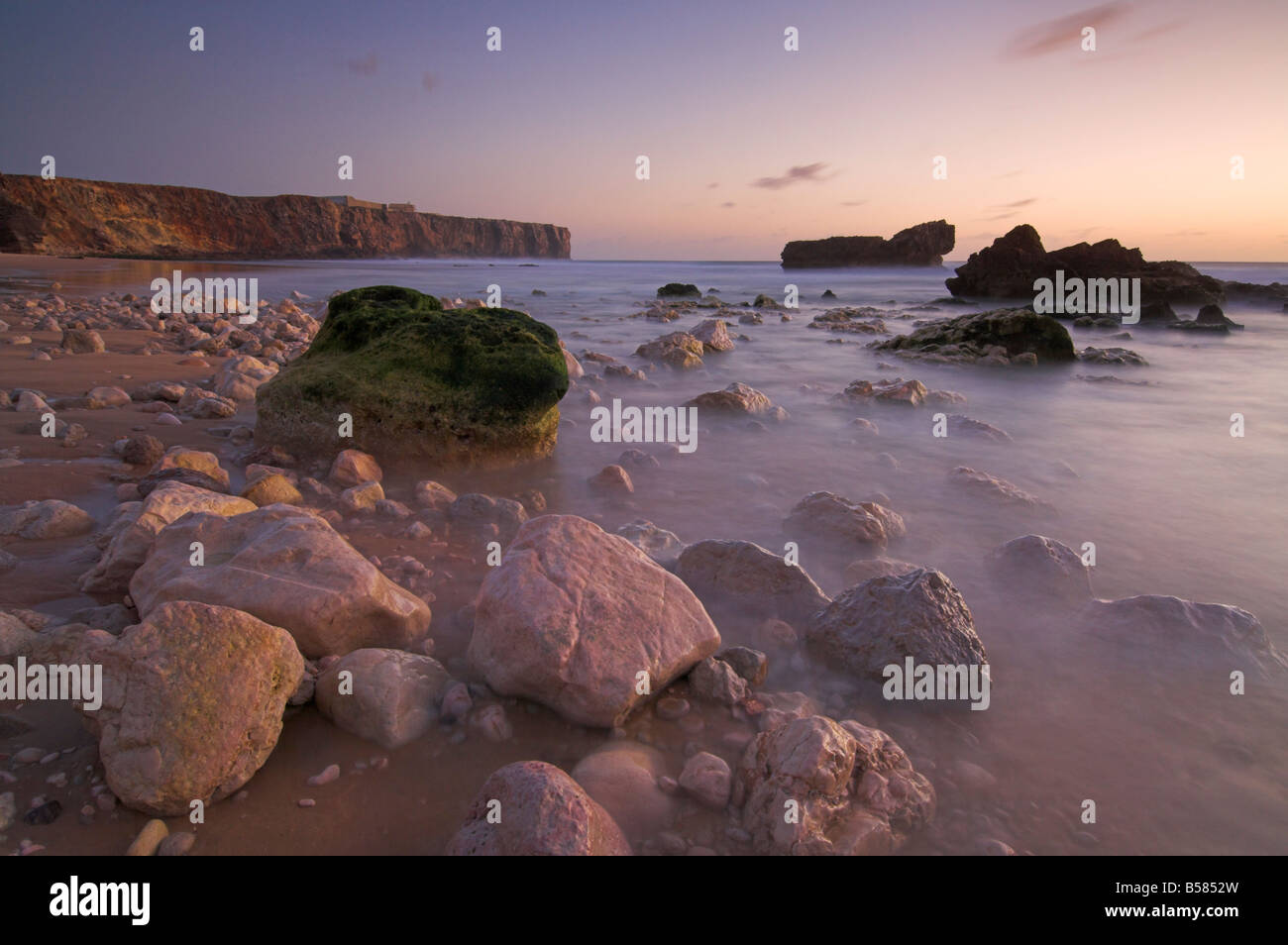 Long exposure of incoming tide on Tonal beach at sunset near Sagres ...