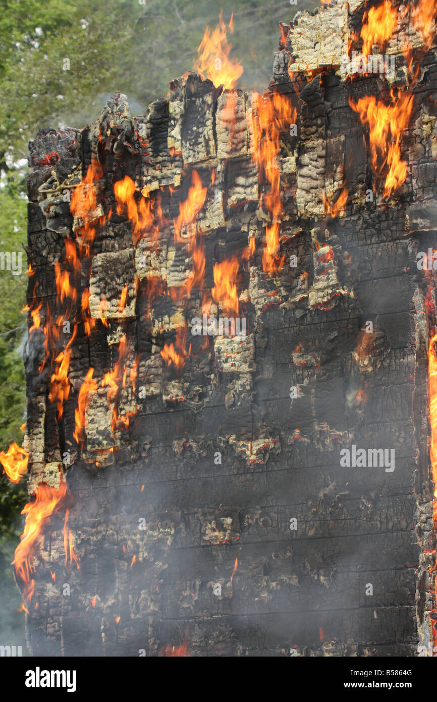 The siding of a house that is burning down Smoke has appeared creating ...