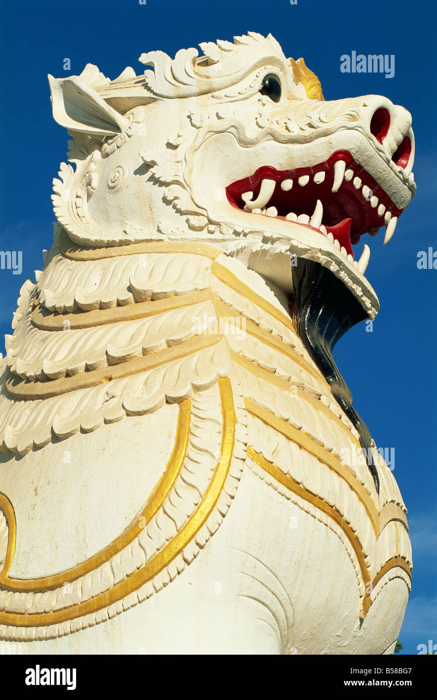 Close up of the huge lion statue chinthe at the foot of the stairs to ...