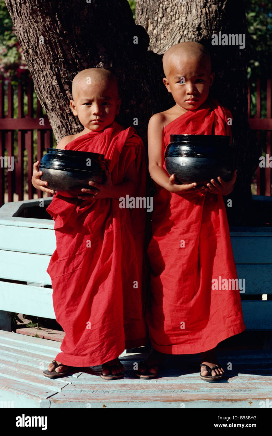 Two child novice monks holding bowls Shwe Nandaw Monastery Mandalay ...
