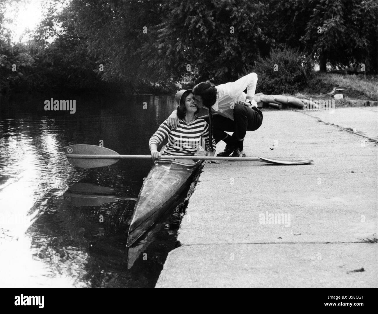 Ray Haynes kisses his wife Janice goodbye as she sets off to paddle to ...